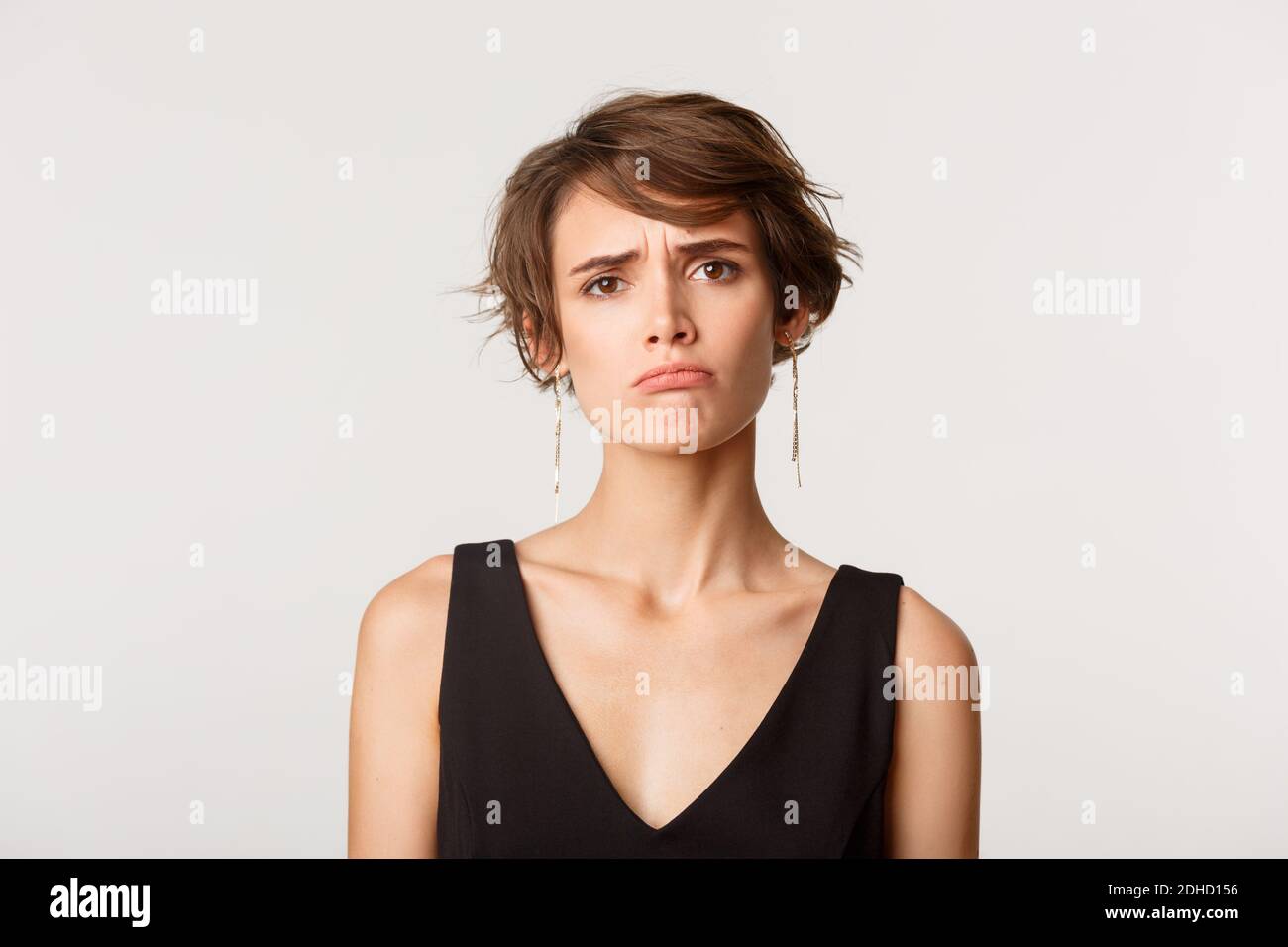 Close-up of distressed young gloomy woman frowning and pouting ...