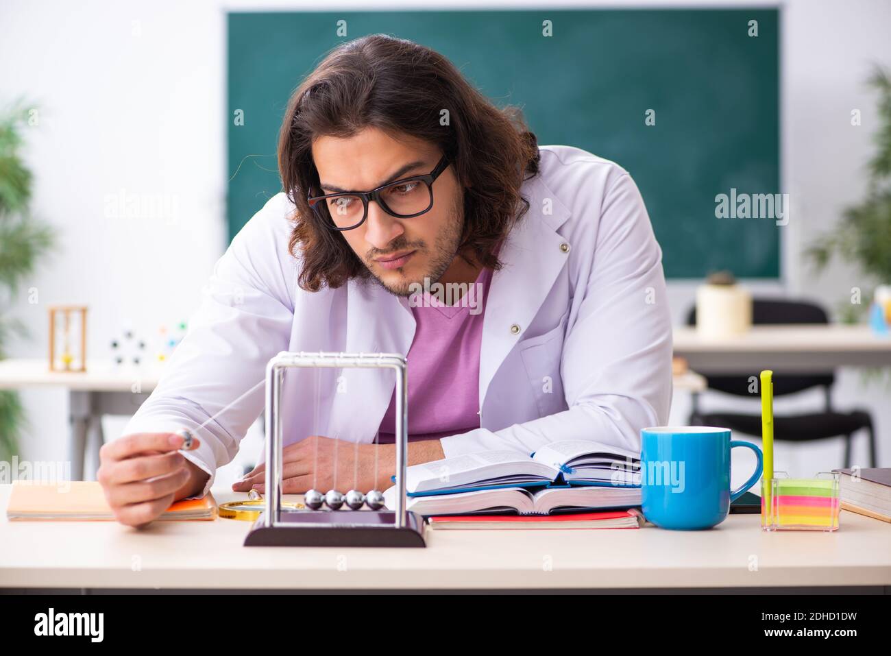 Young male physicist in the classroom Stock Photo - Alamy