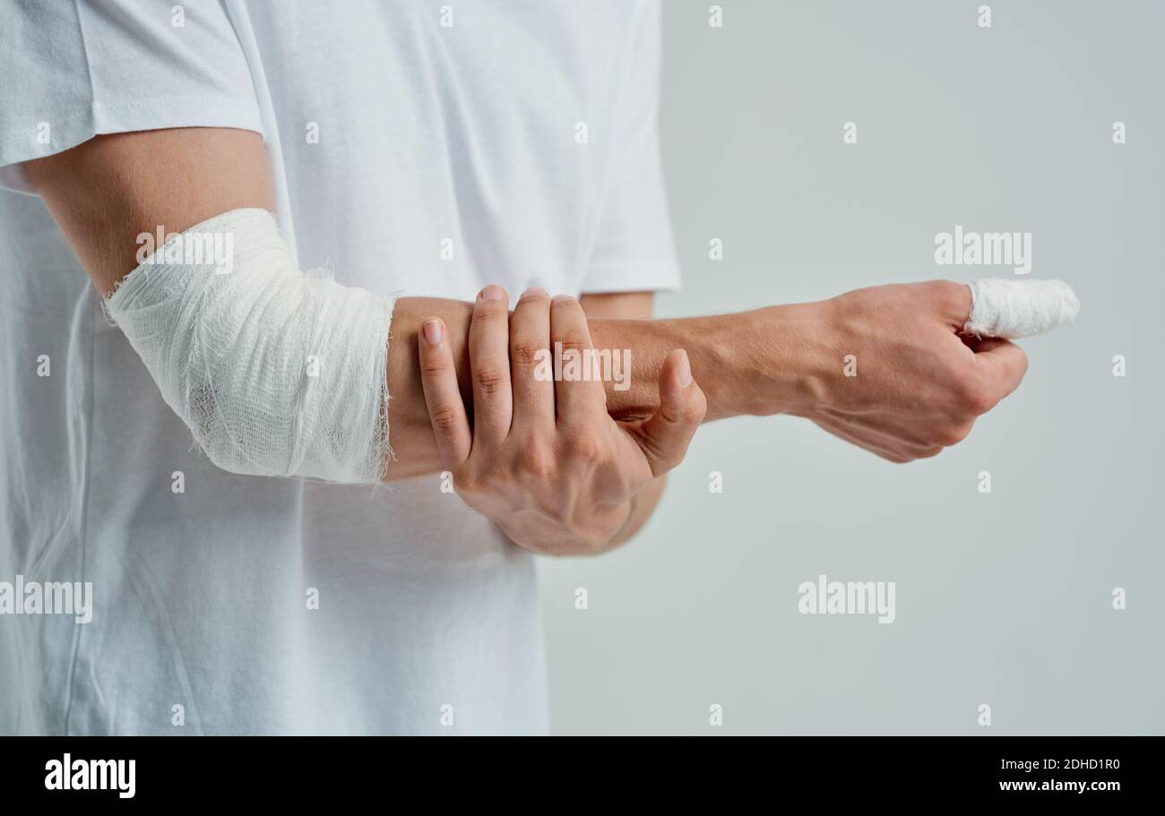 man with bandaged arm elbow and finger injury medicine Stock Photo - Alamy
