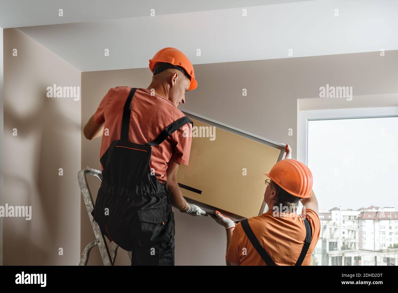 Workers Are Installing A Split System For A Home Air Conditioning