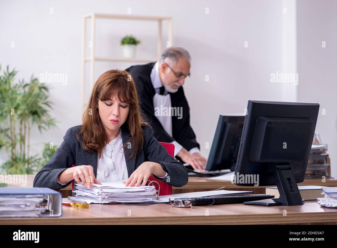 Old male judge and his young secretary in the office Stock Photo - Alamy