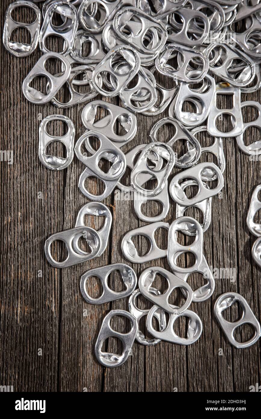Close up rings pull aluminum of soda or beer metal can isolate on wood ...