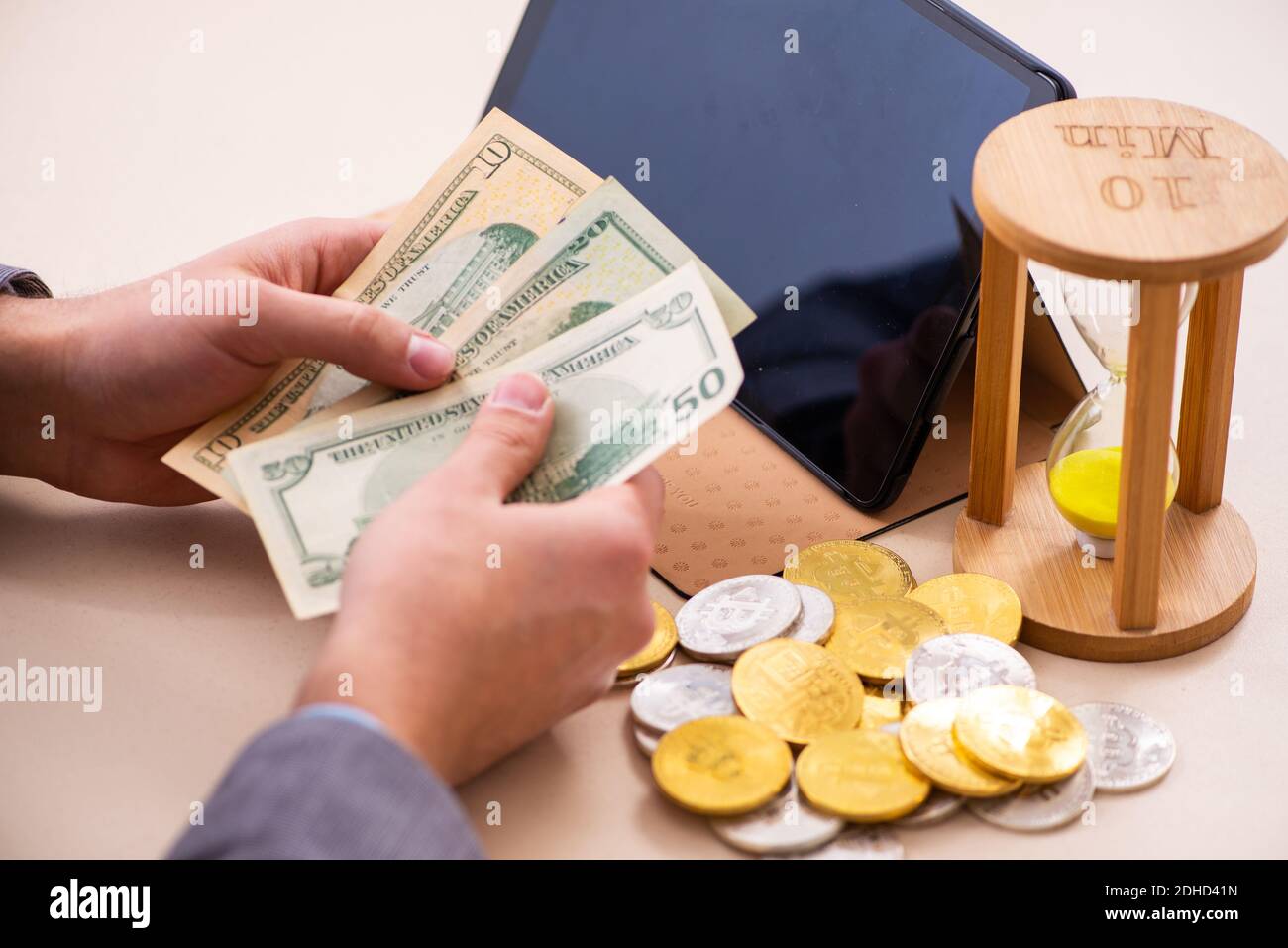 Young man earning money via Internet in time management concept Stock ...