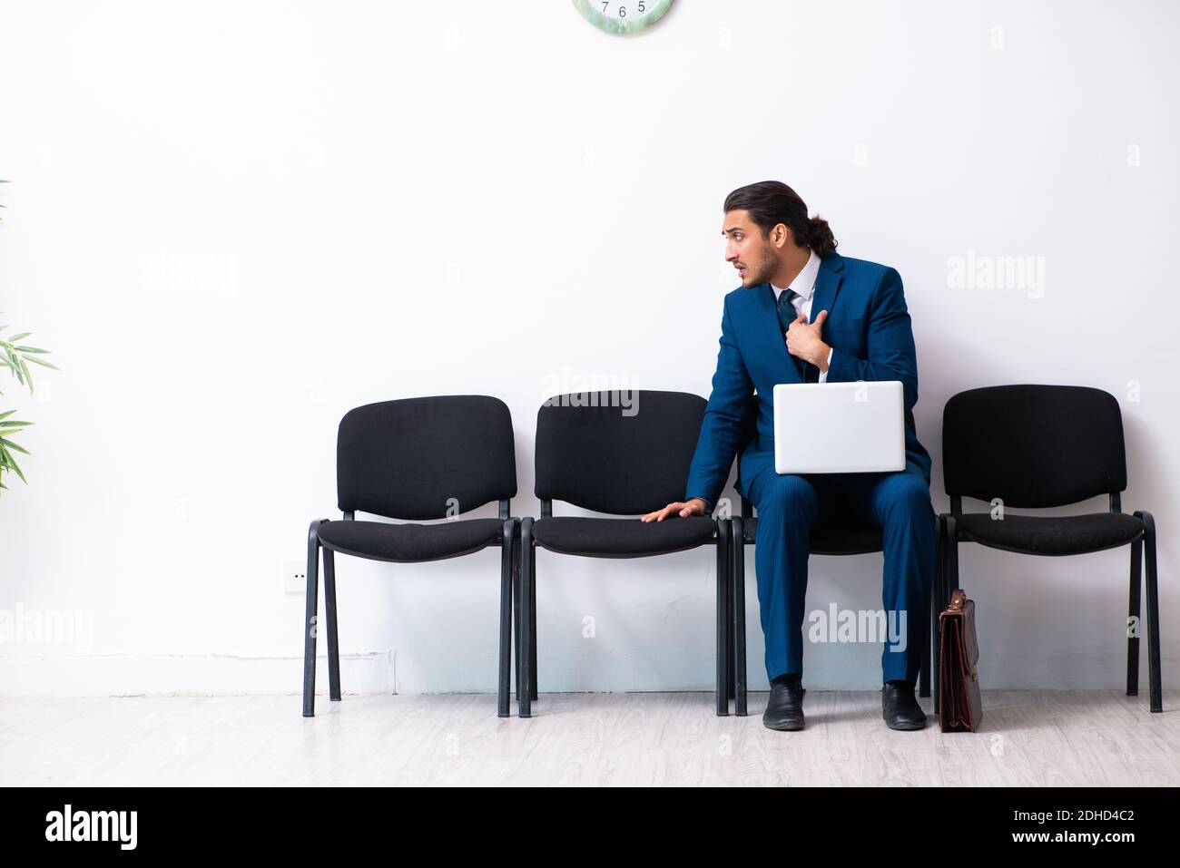 Young businessman waiting for an interview at hall Stock Photo - Alamy