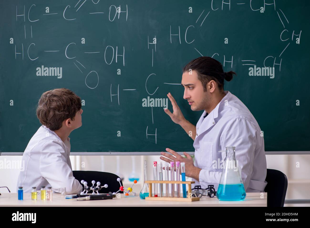 Young chemistry teacher and schoolboy in the classroom Stock Photo - Alamy