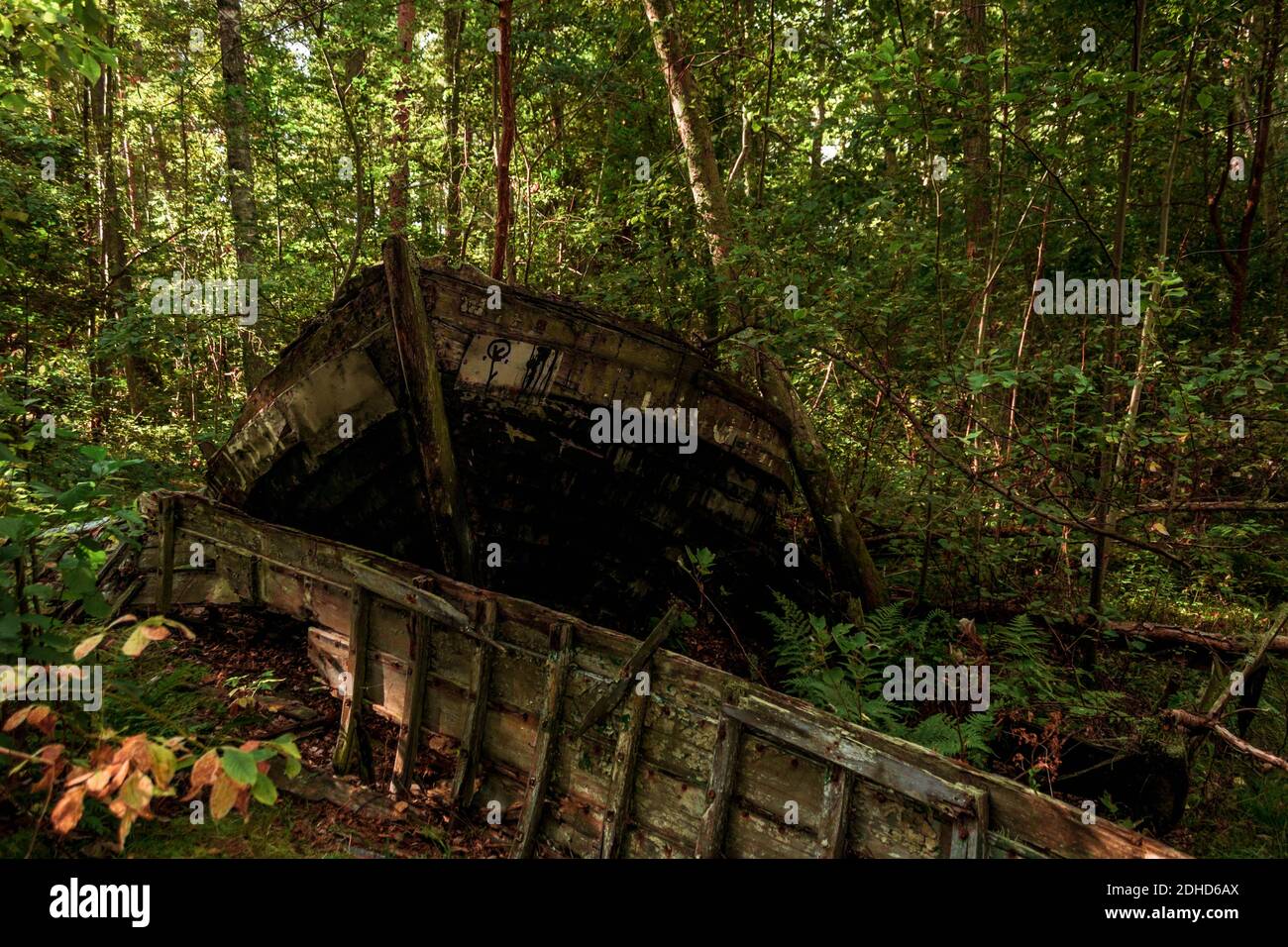 Stern of old, abandoned, dilapidated boat with remnants of other boats ...