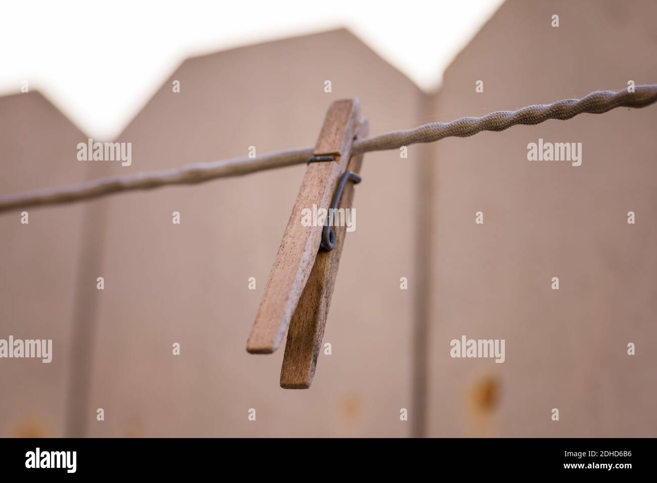 A single clothespin hanging on a clothesline Stock Photo - Alamy