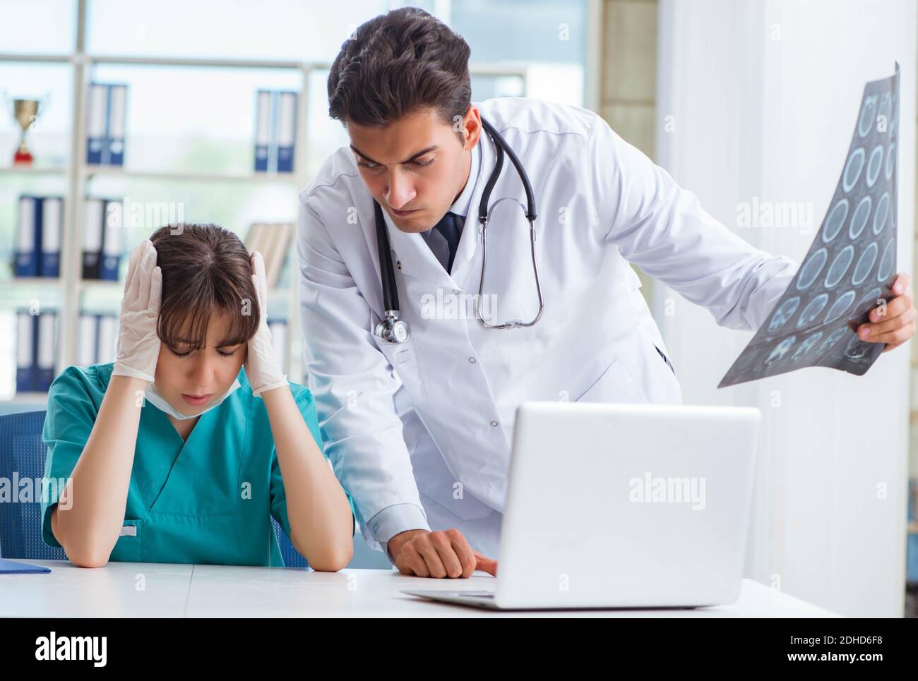 Two doctors discussing x-ray MRI image in hospital Stock Photo - Alamy