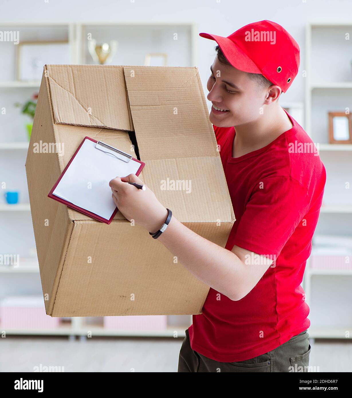 Post man delivering a parcel package Stock Photo - Alamy