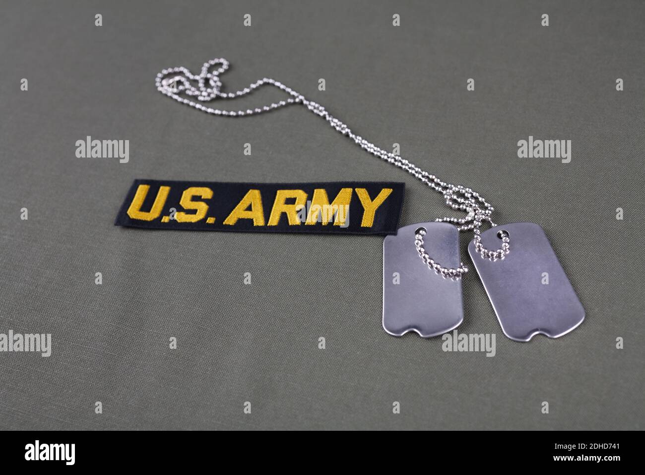 U.S. Army Branch Tape with dog tags on olive drab uniform background ...
