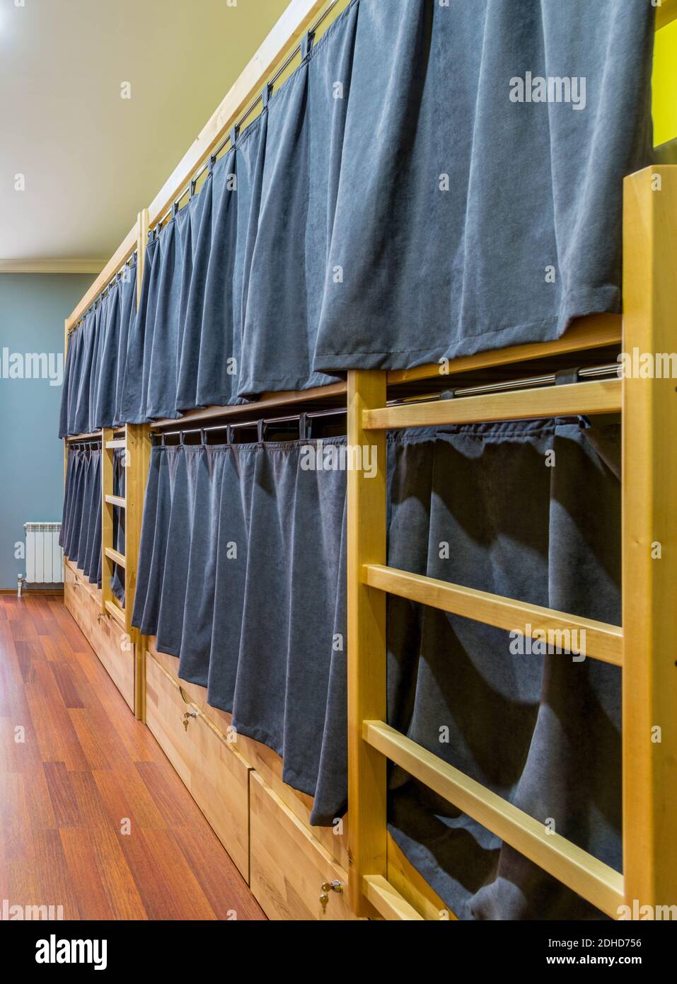 Hostel dormitory beds arranged in room Stock Photo - Alamy