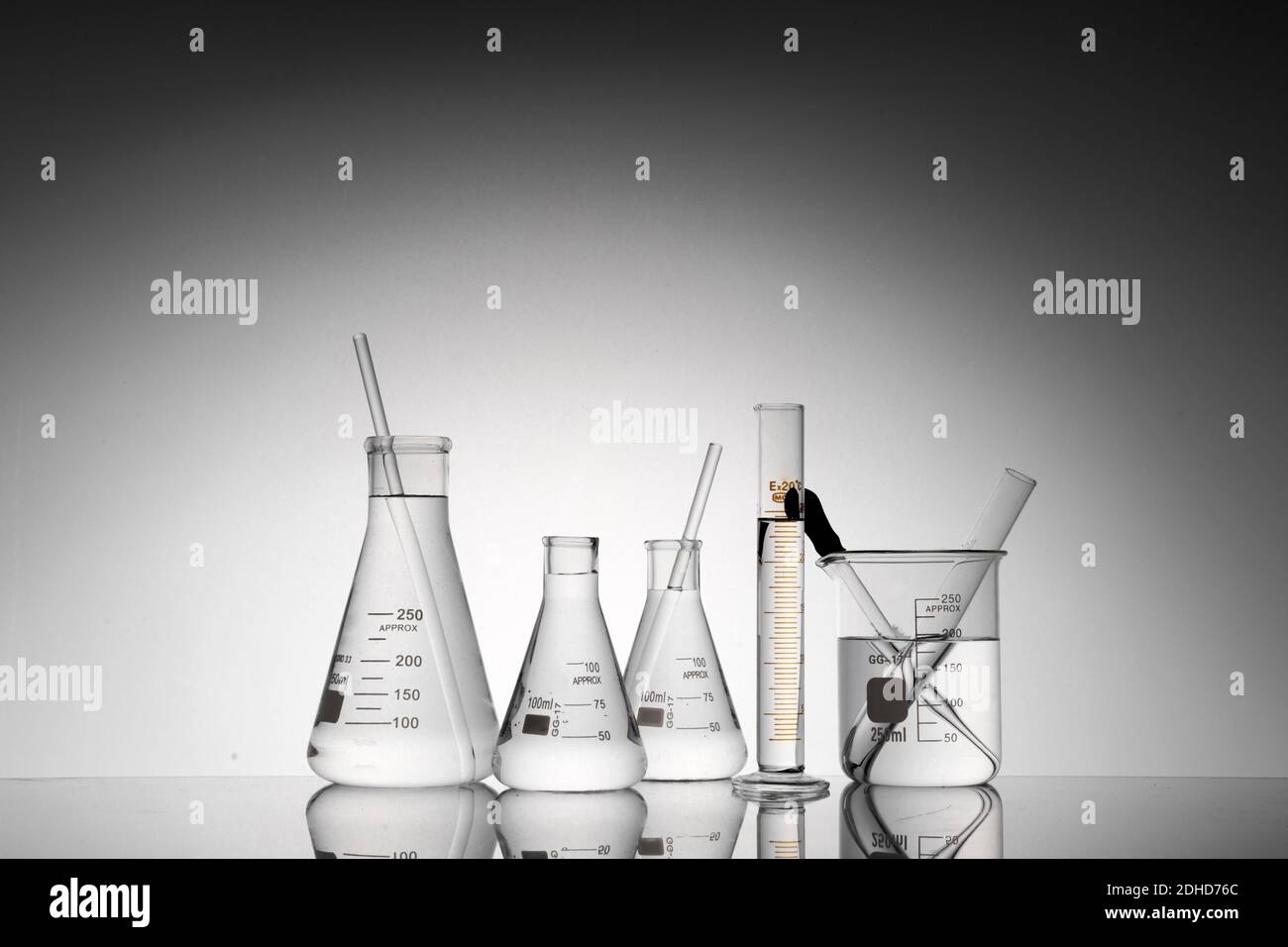 A closeup shot of transparent laboratory flasks, beakers, and tubes ...