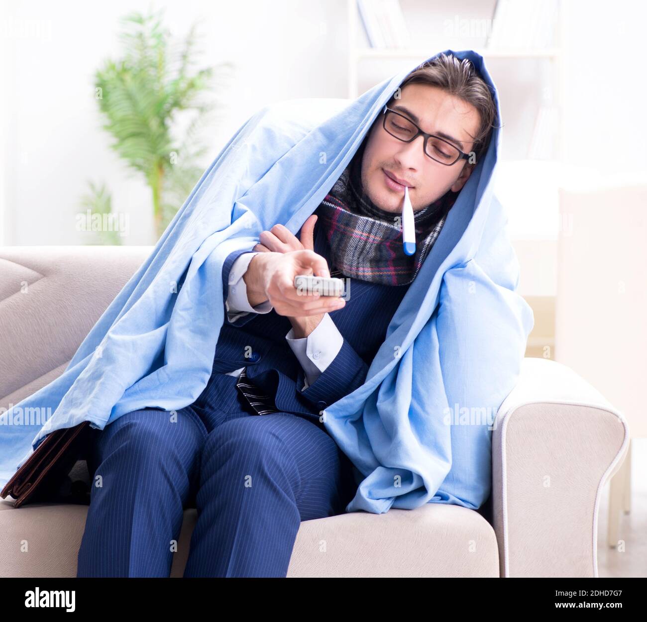 Employee businessman watching tv while being sick with flu Stock Photo ...