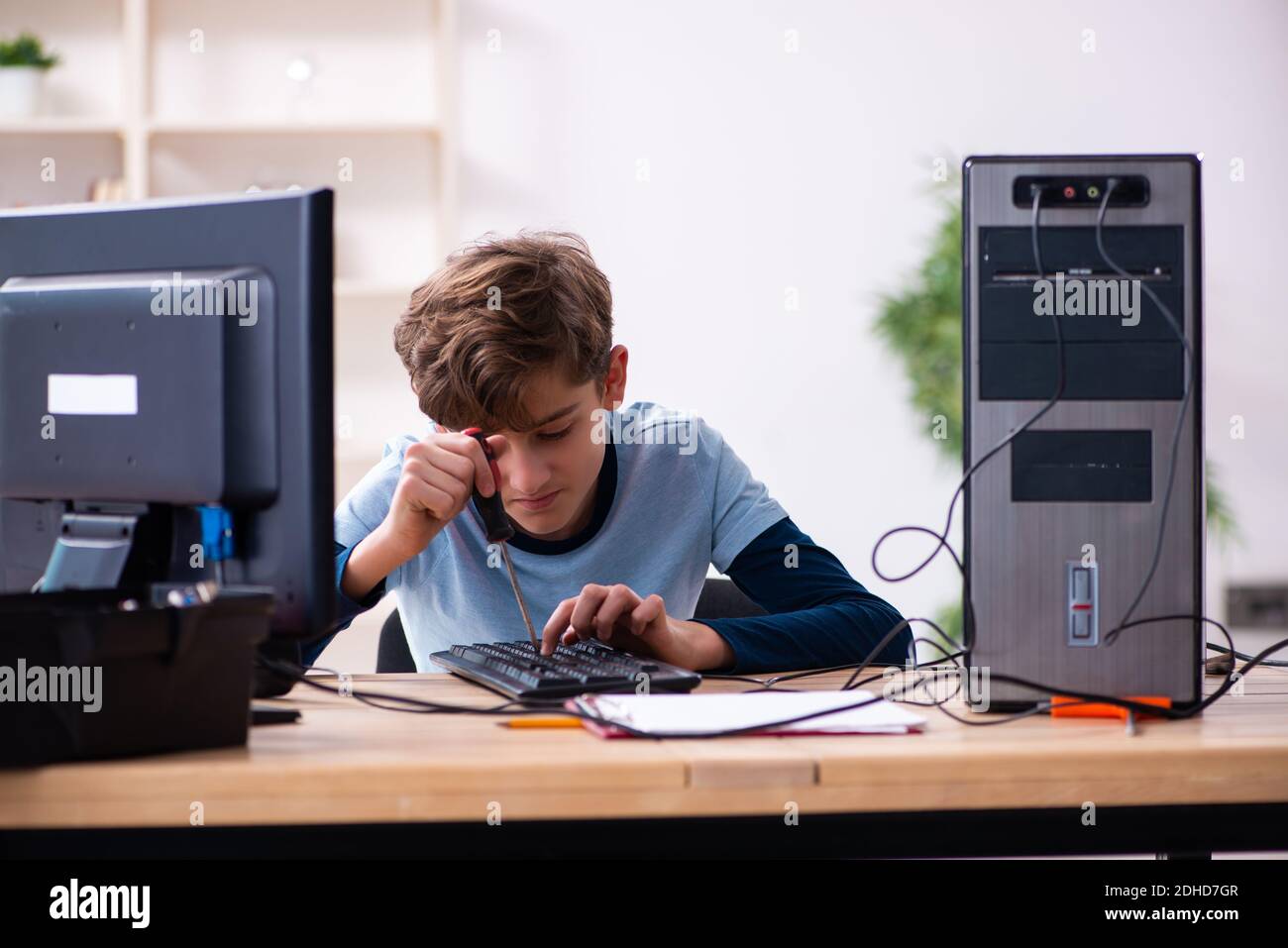 Boy reparing computers at workshop Stock Photo - Alamy