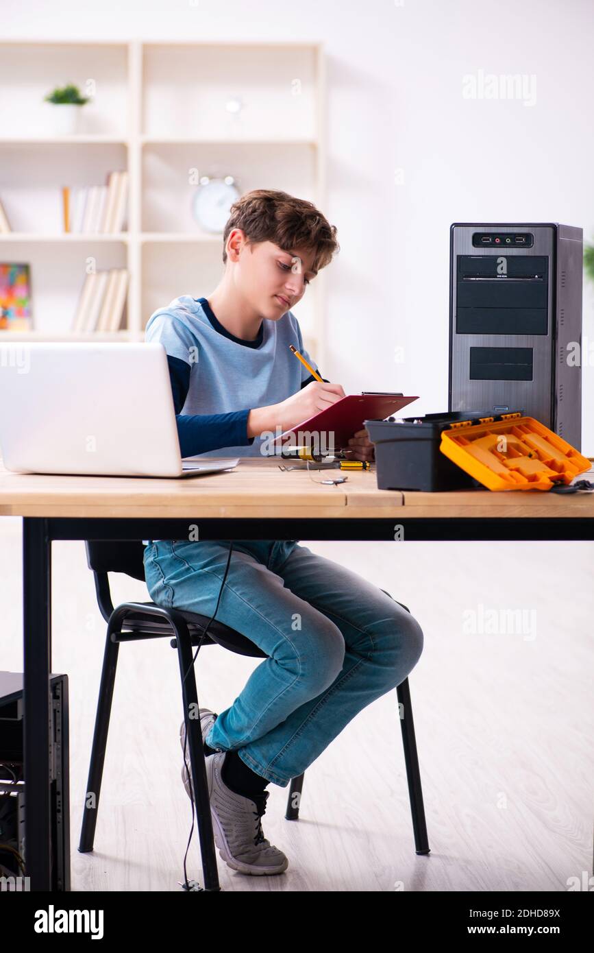 Boy reparing computers at workshop Stock Photo - Alamy