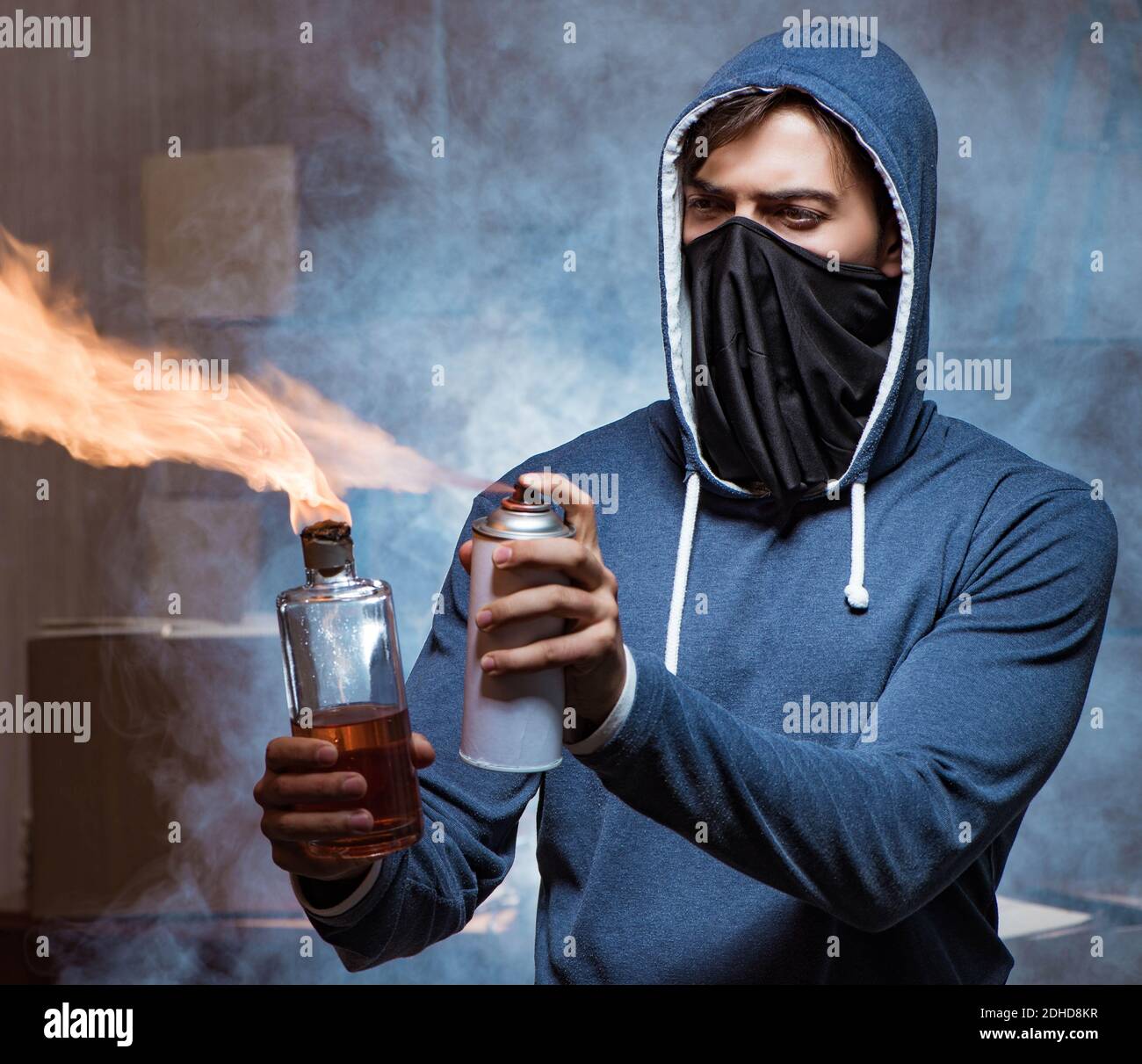 Rebel with molotov cocktail in dark room Stock Photo - Alamy