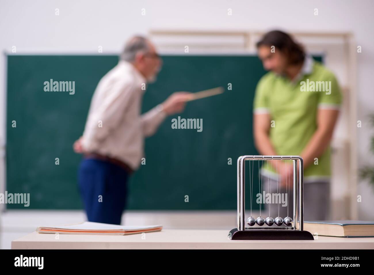 Old professor physicist and young student in the classroom Stock Photo ...