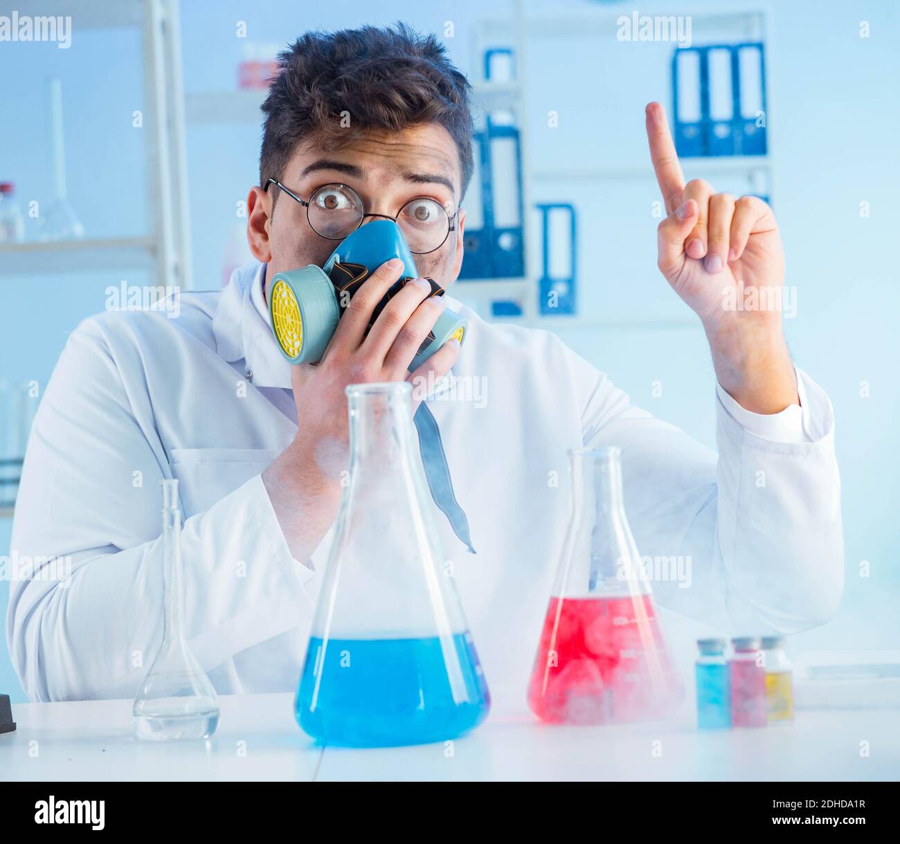 Funny mad chemist working in a laboratory Stock Photo - Alamy