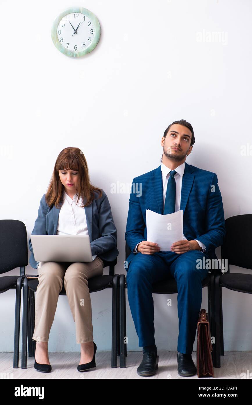 Young businessman and businesswoman waiting for an interview at Stock ...