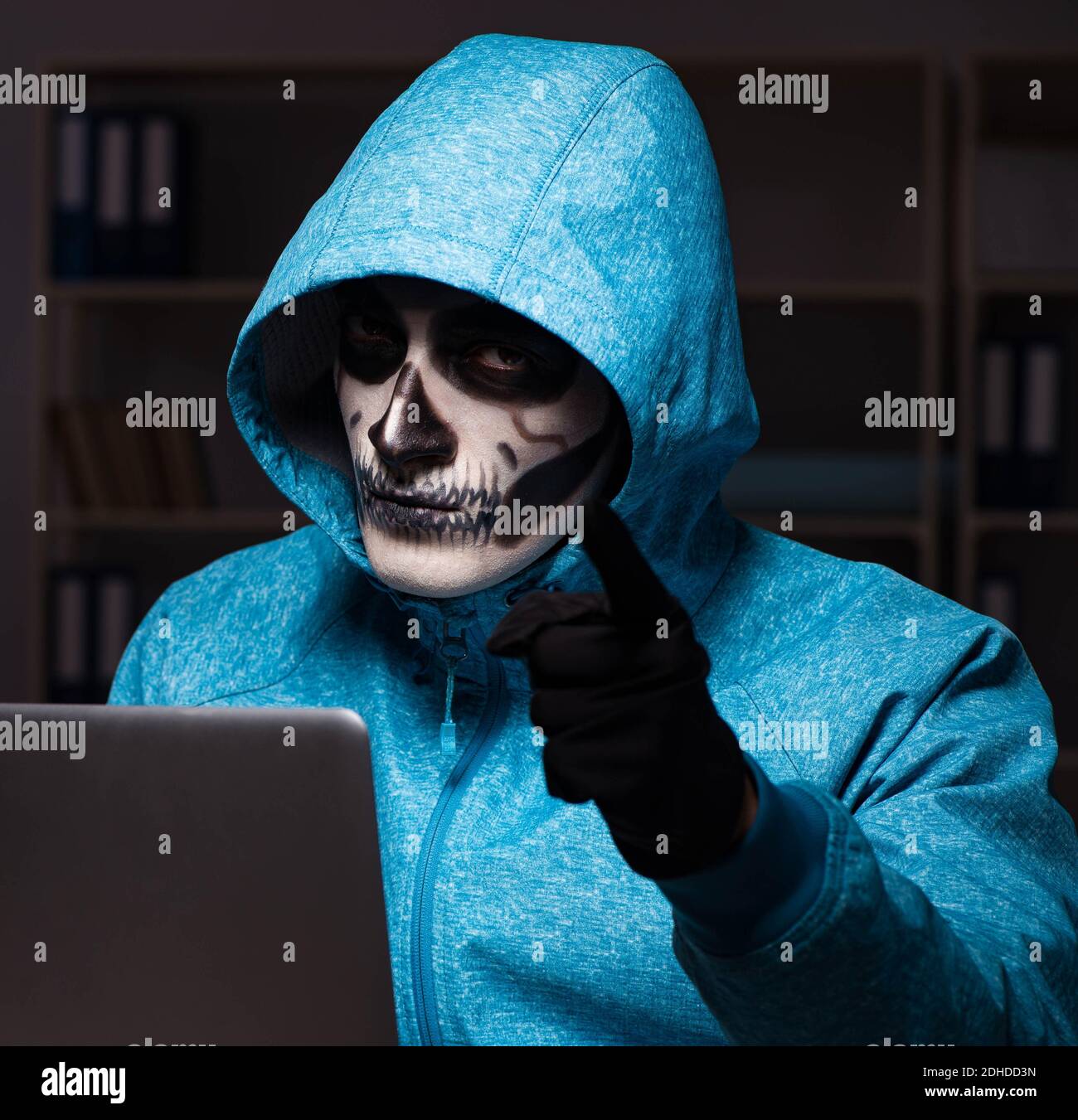 Scary hacker hacking security firewall late in office Stock Photo - Alamy