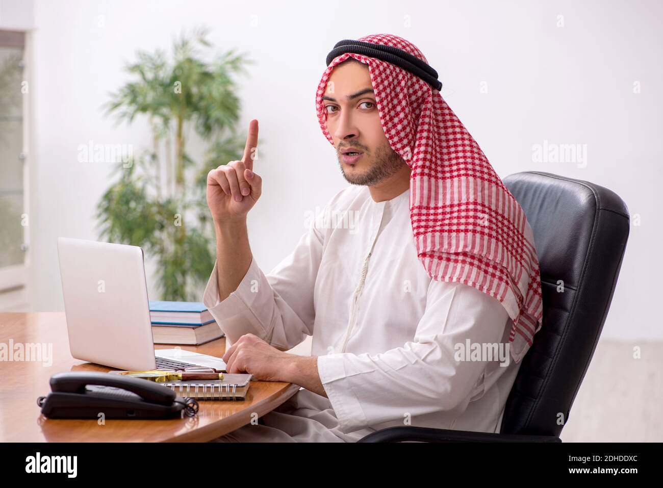 Young male arab employee working in the office Stock Photo - Alamy