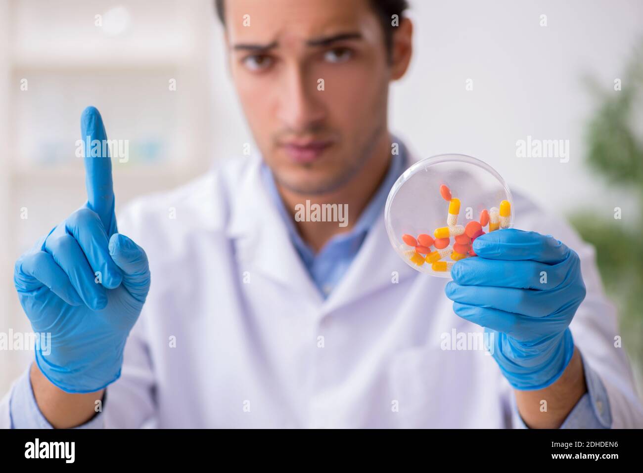 Young male lab assistant in drug synthesis concept Stock Photo - Alamy