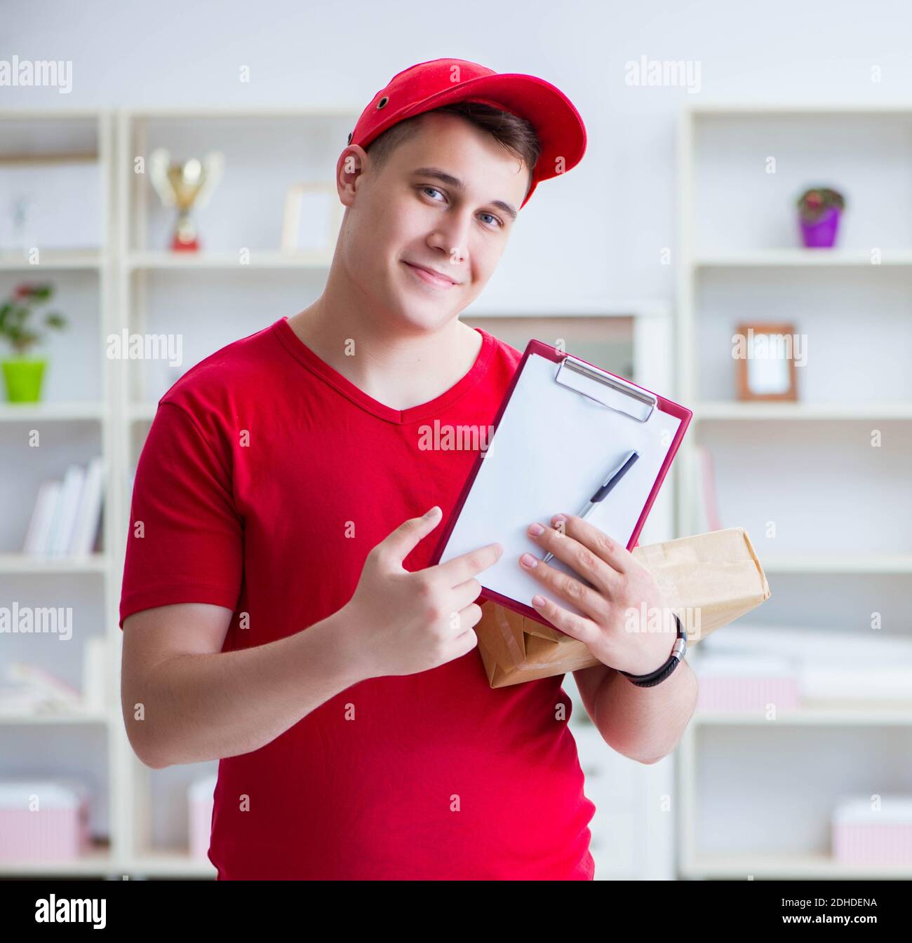 Post man delivering a parcel package Stock Photo - Alamy