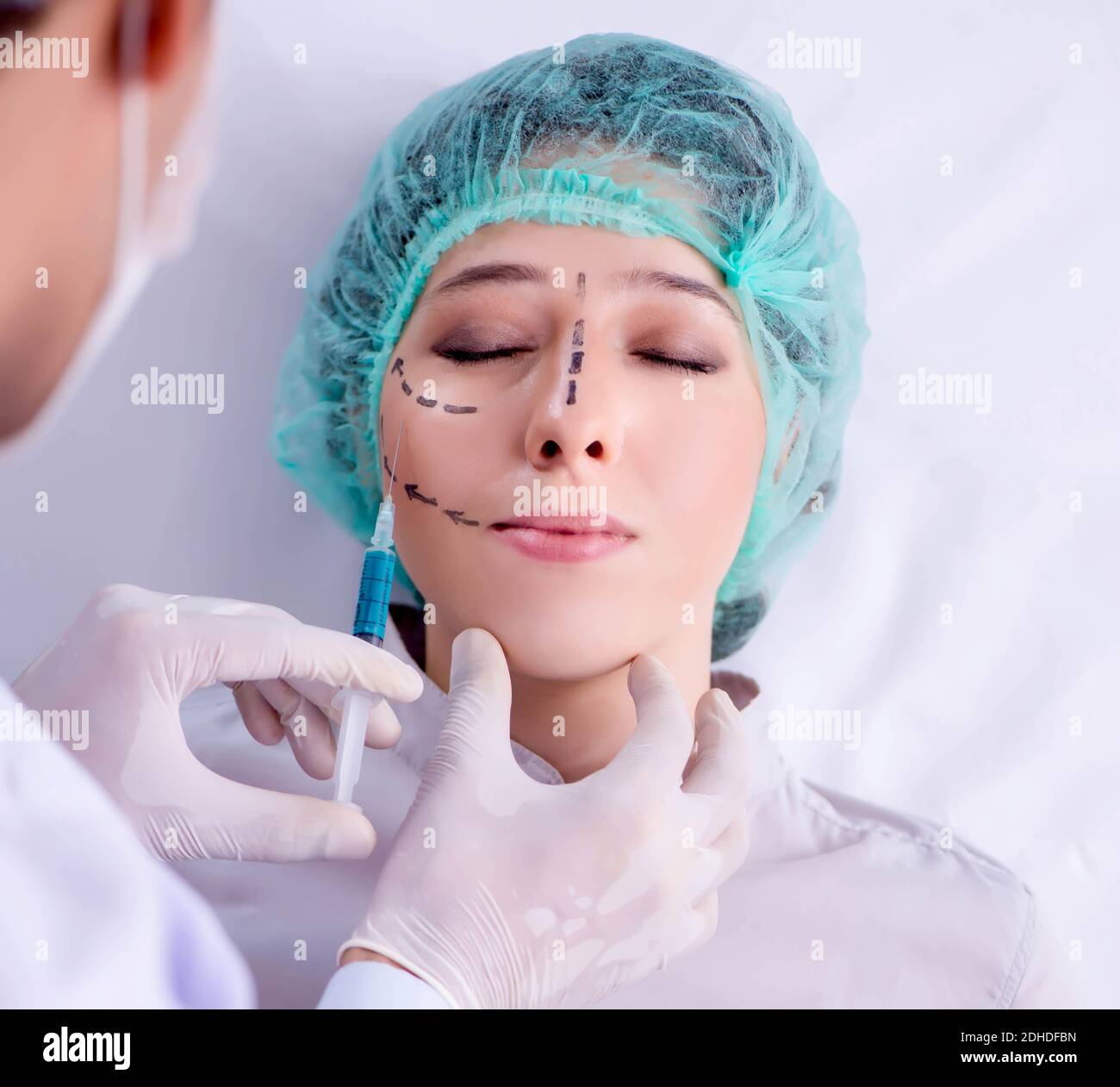 Plastic surgeon preparing for operation on woman face Stock Photo - Alamy