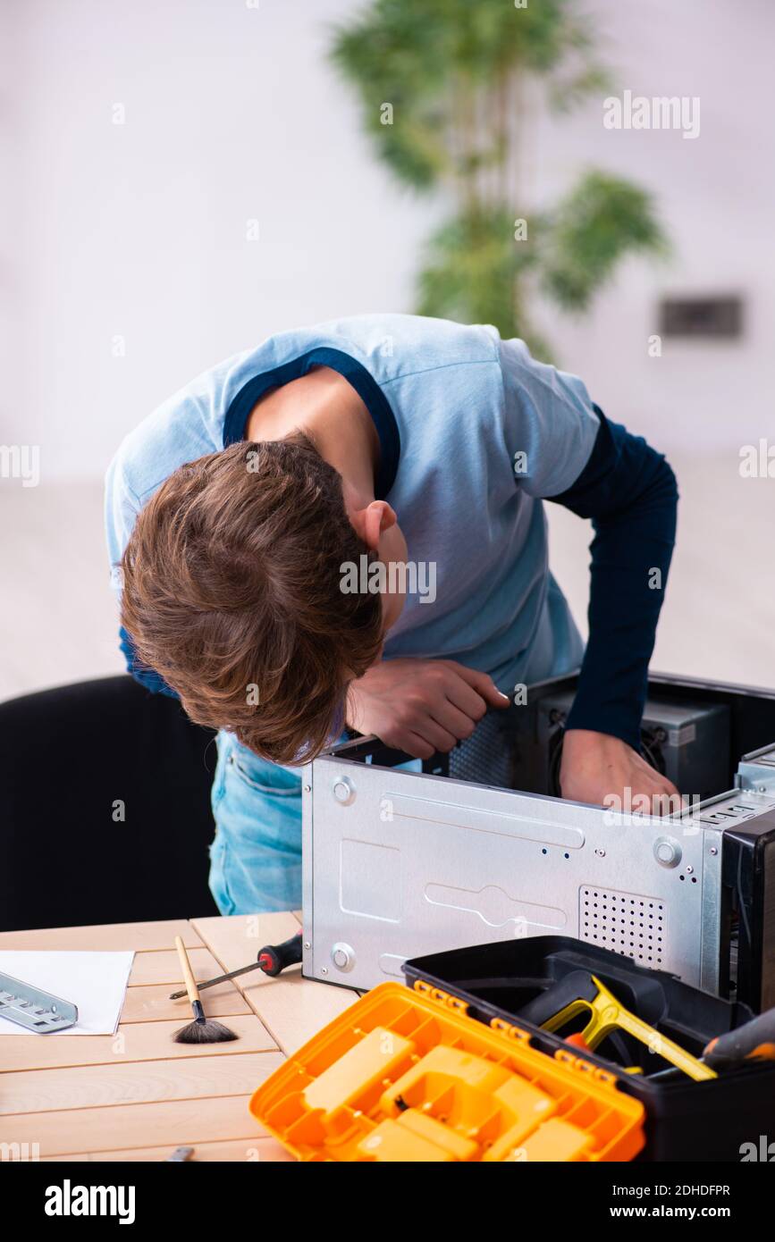 Boy reparing computers at workshop Stock Photo - Alamy