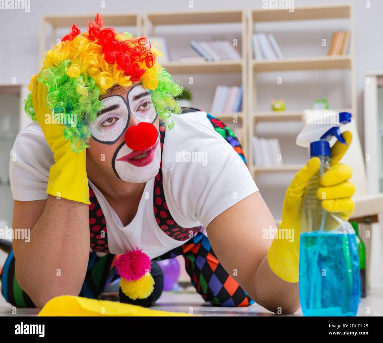 Funny clown doing cleaning at home Stock Photo - Alamy