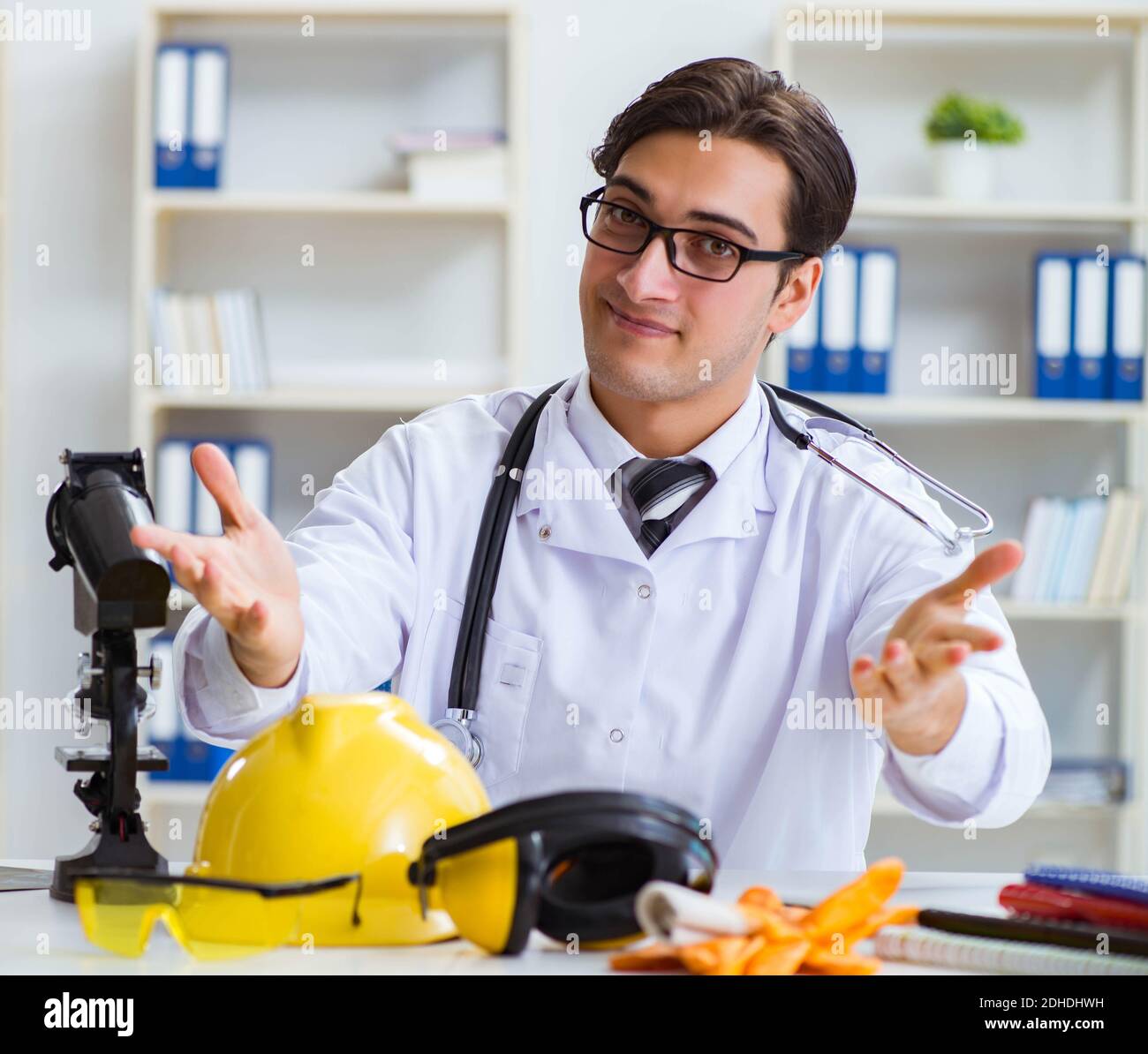 Safety doctor advising about wearing hard hat Stock Photo - Alamy