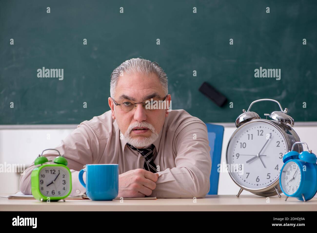 Old male teacher in the classroom Stock Photo - Alamy