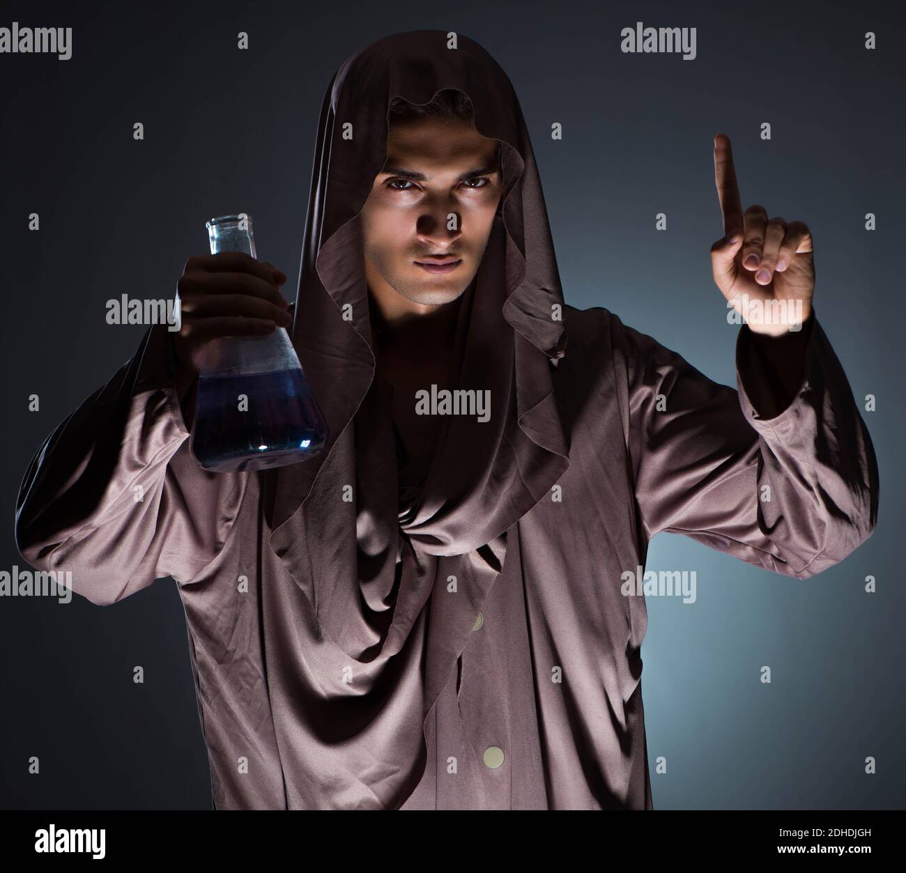 Alchemist doing experiments in alchemy concept Stock Photo - Alamy
