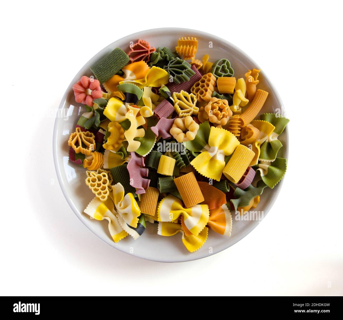 Multicolored italian pasta in plate, isolated Stock Photo - Alamy