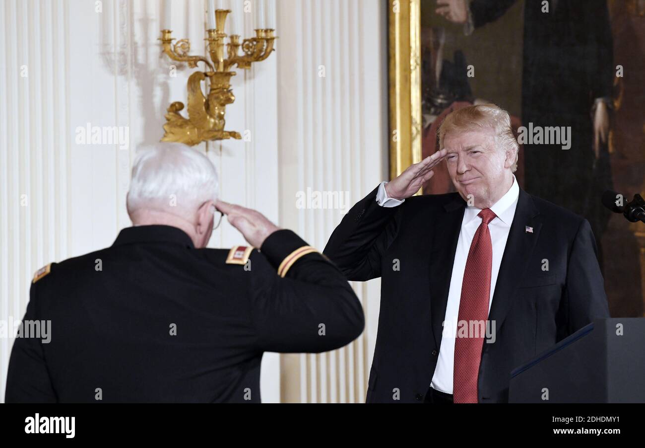 U.S. President Donald Trump salutes back at retired Army Capt. Gary M ...