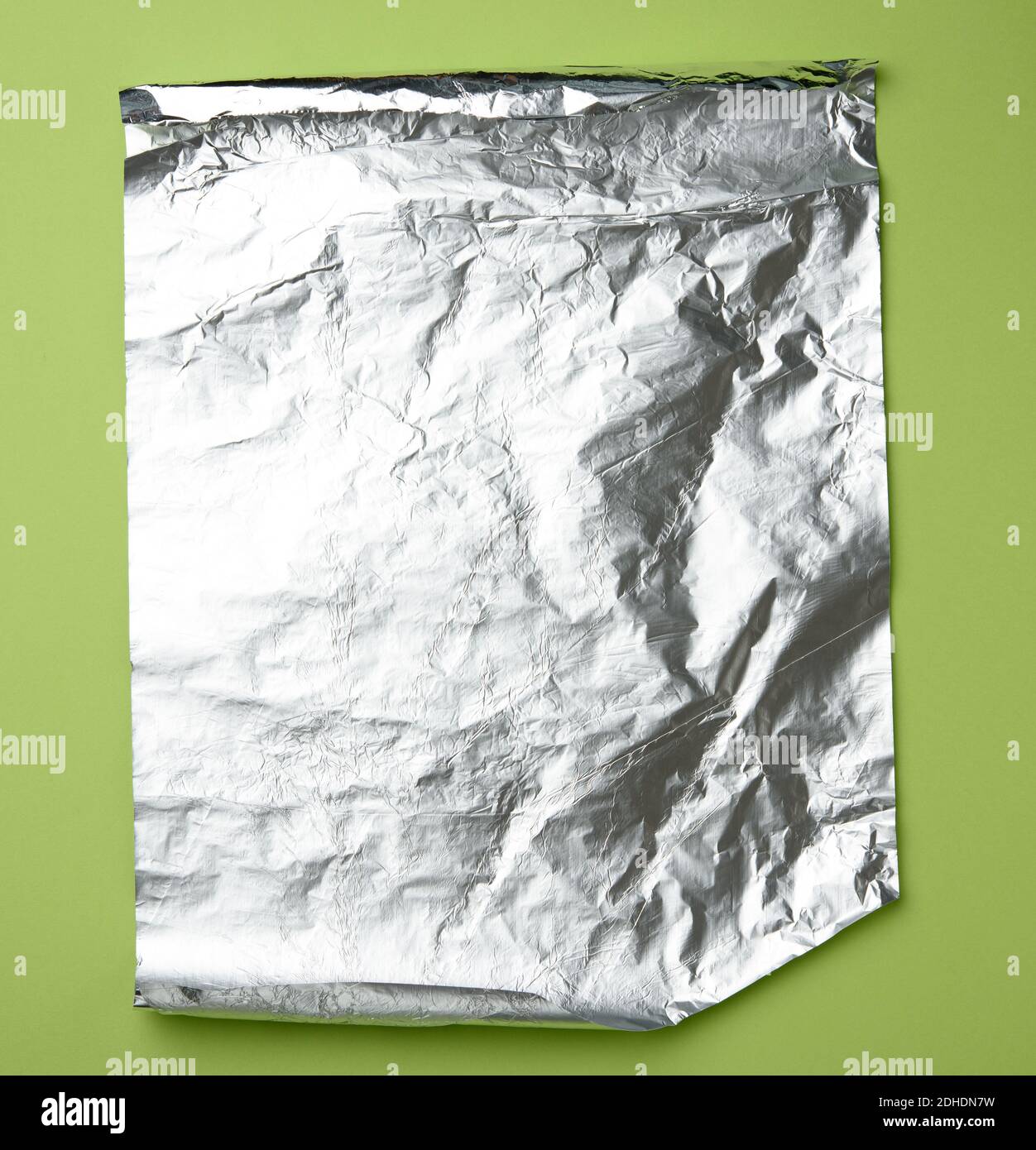 Gray foil for baking and packaging food on a green background Stock ...