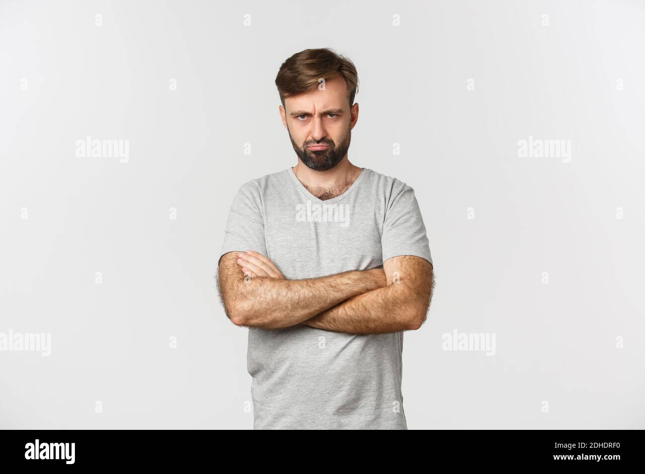 Portrait of offended handsome man, sulking and making angry grimace ...