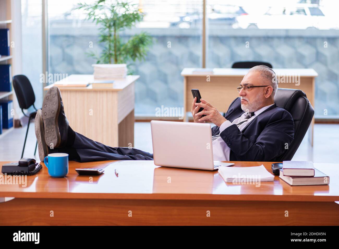Old businessman employee working in the office Stock Photo - Alamy