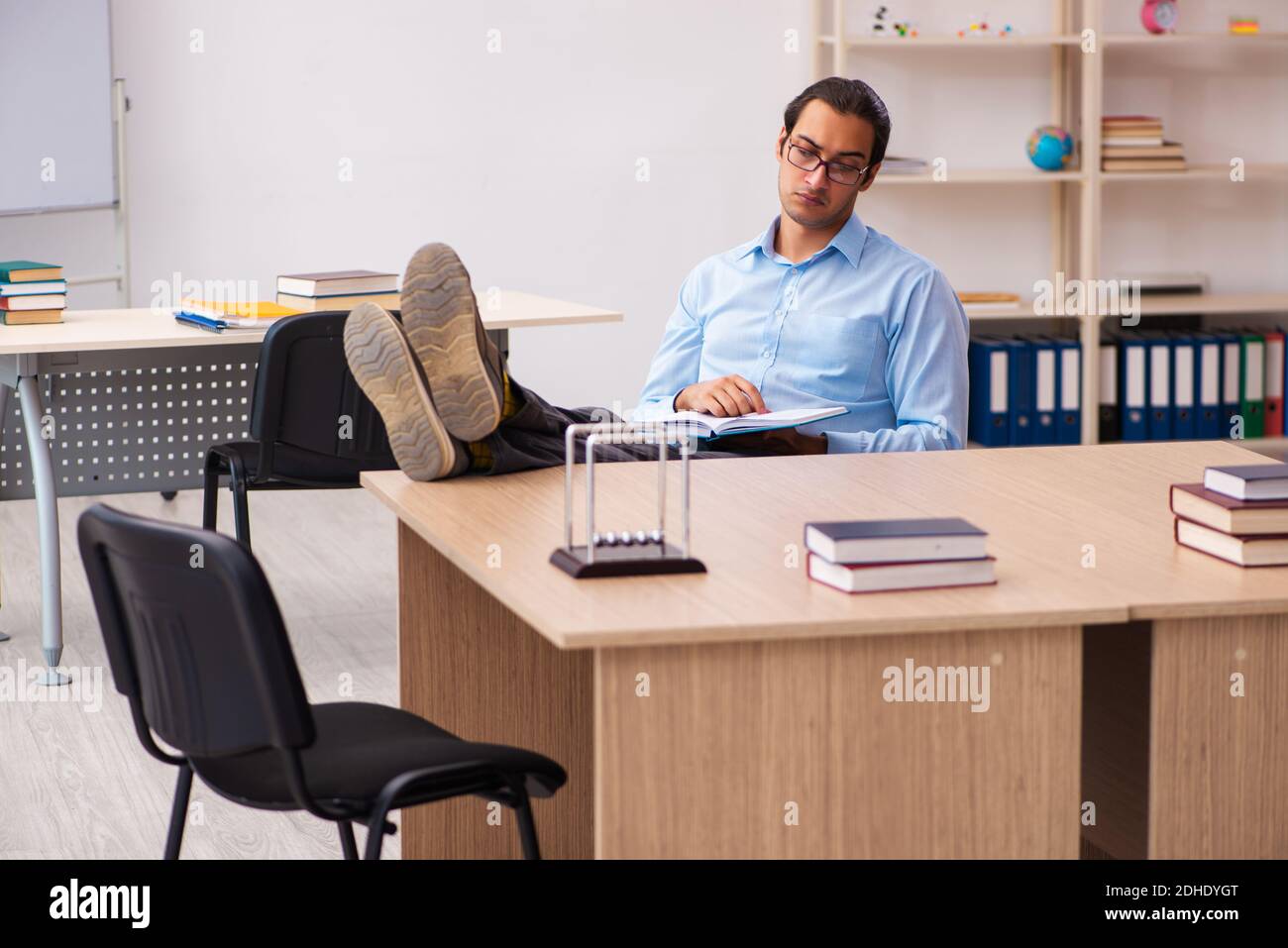 Young male teacher in the classroom Stock Photo - Alamy