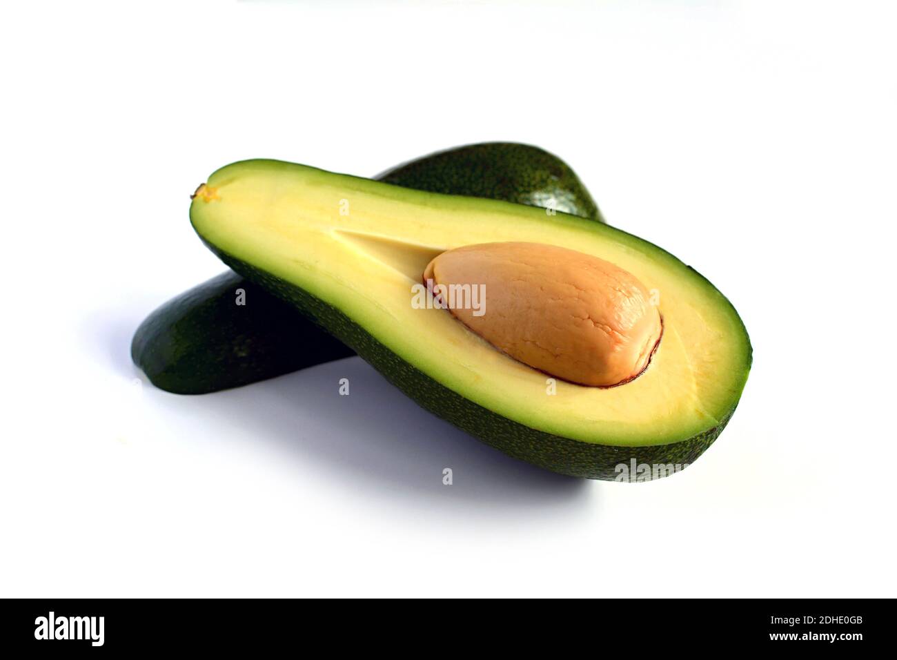 Fresh avocado cut in half Stock Photo - Alamy