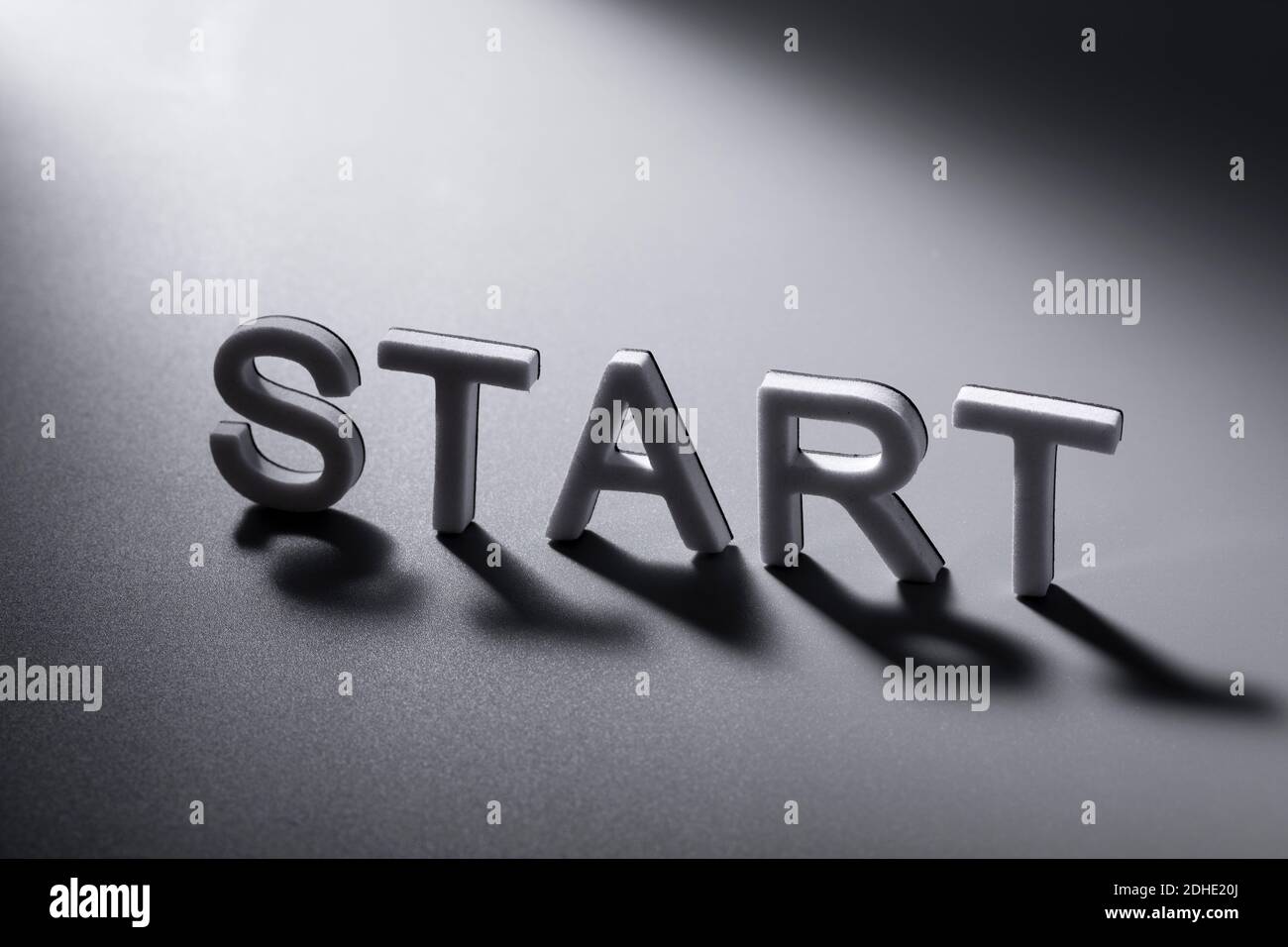 The word "START" written with white plastic letters on a gray ...