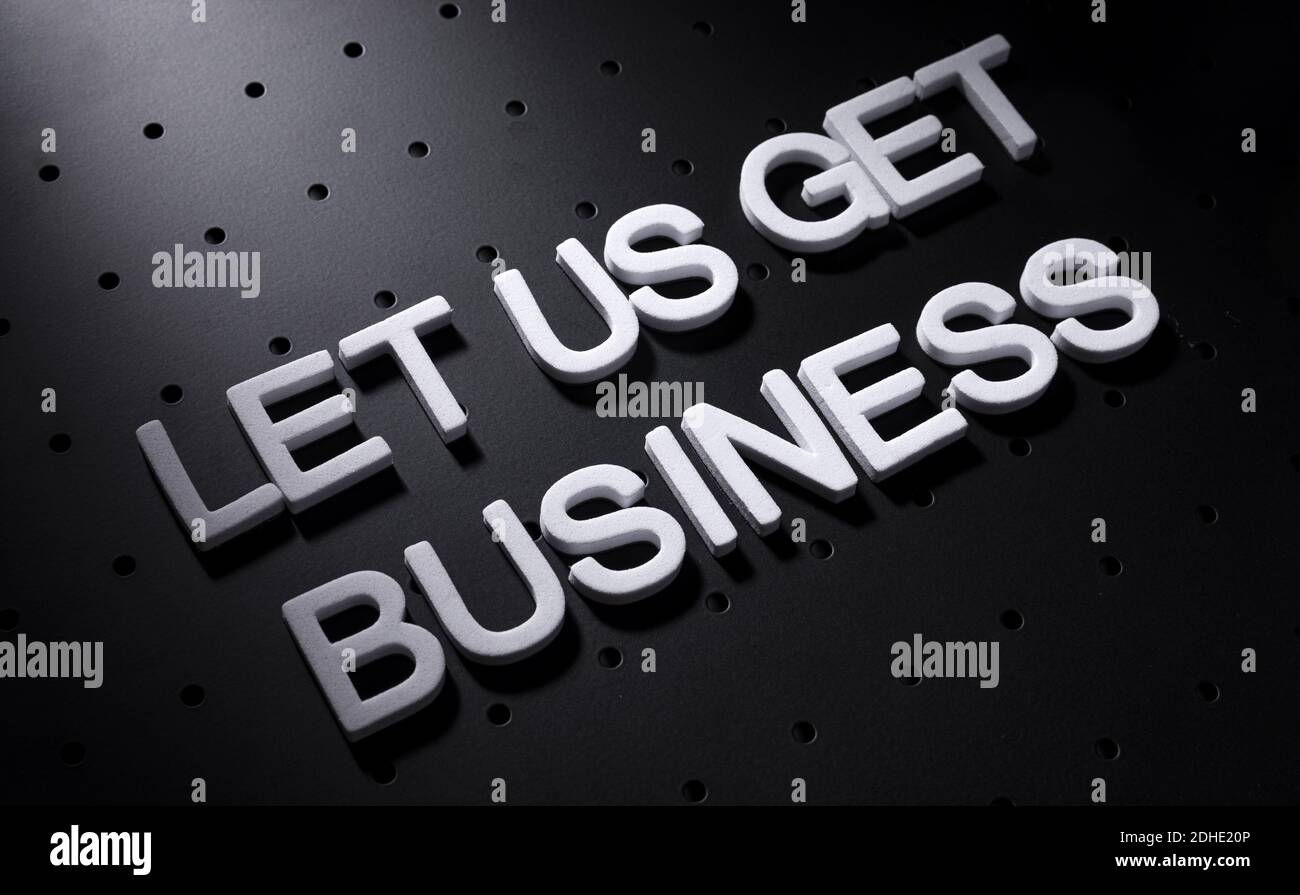 White "LET US GET BUSINESS' text on black spotty background Stock Photo ...