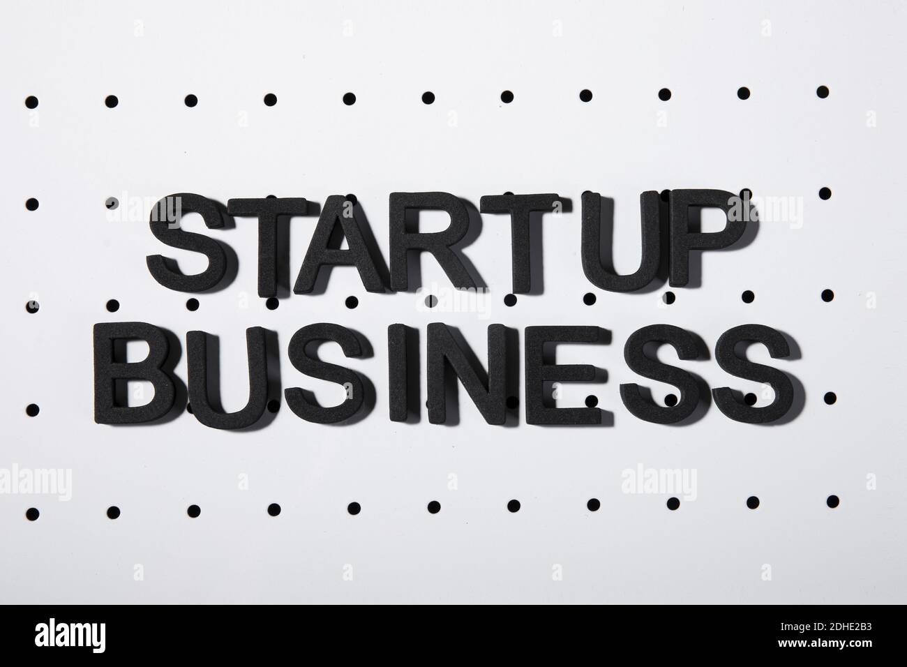 A "STARTUP BUSINESS' text on white spotty background Stock Photo - Alamy