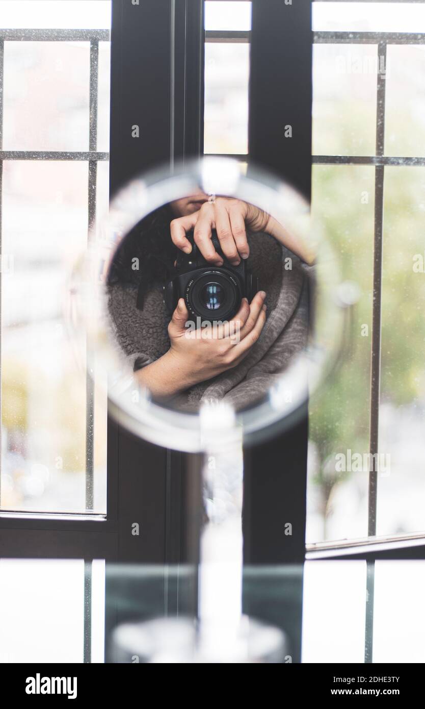 woman's hands with photo camera reflected in the mirror Stock Photo - Alamy