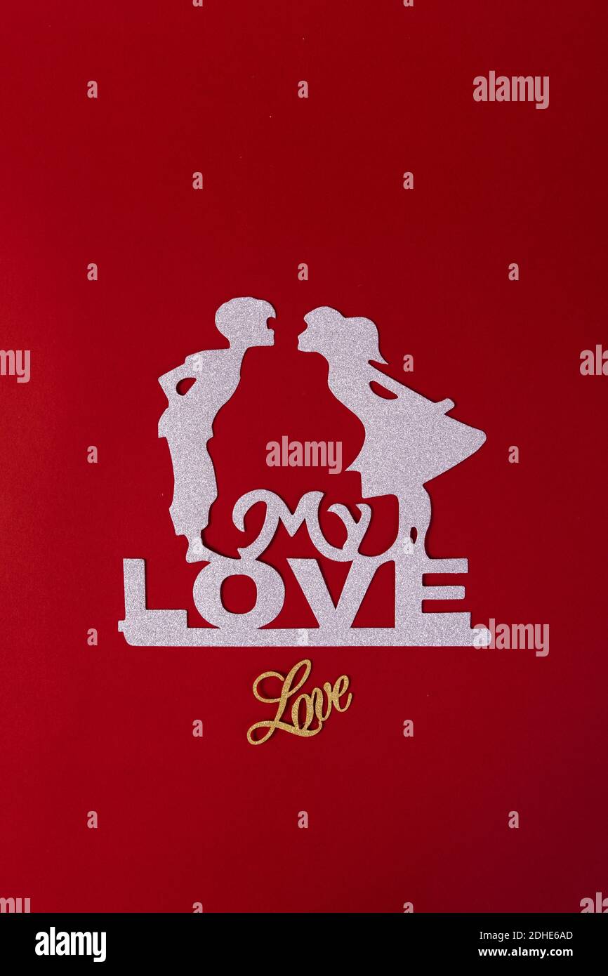 A silver topper "My love" with a kissing couple on the red background ...