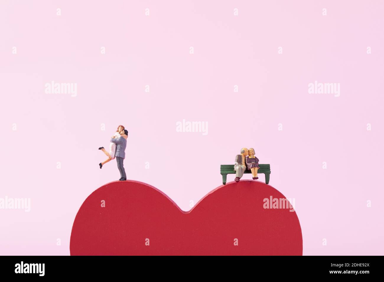 Two different couple figures on heart Stock Photo - Alamy