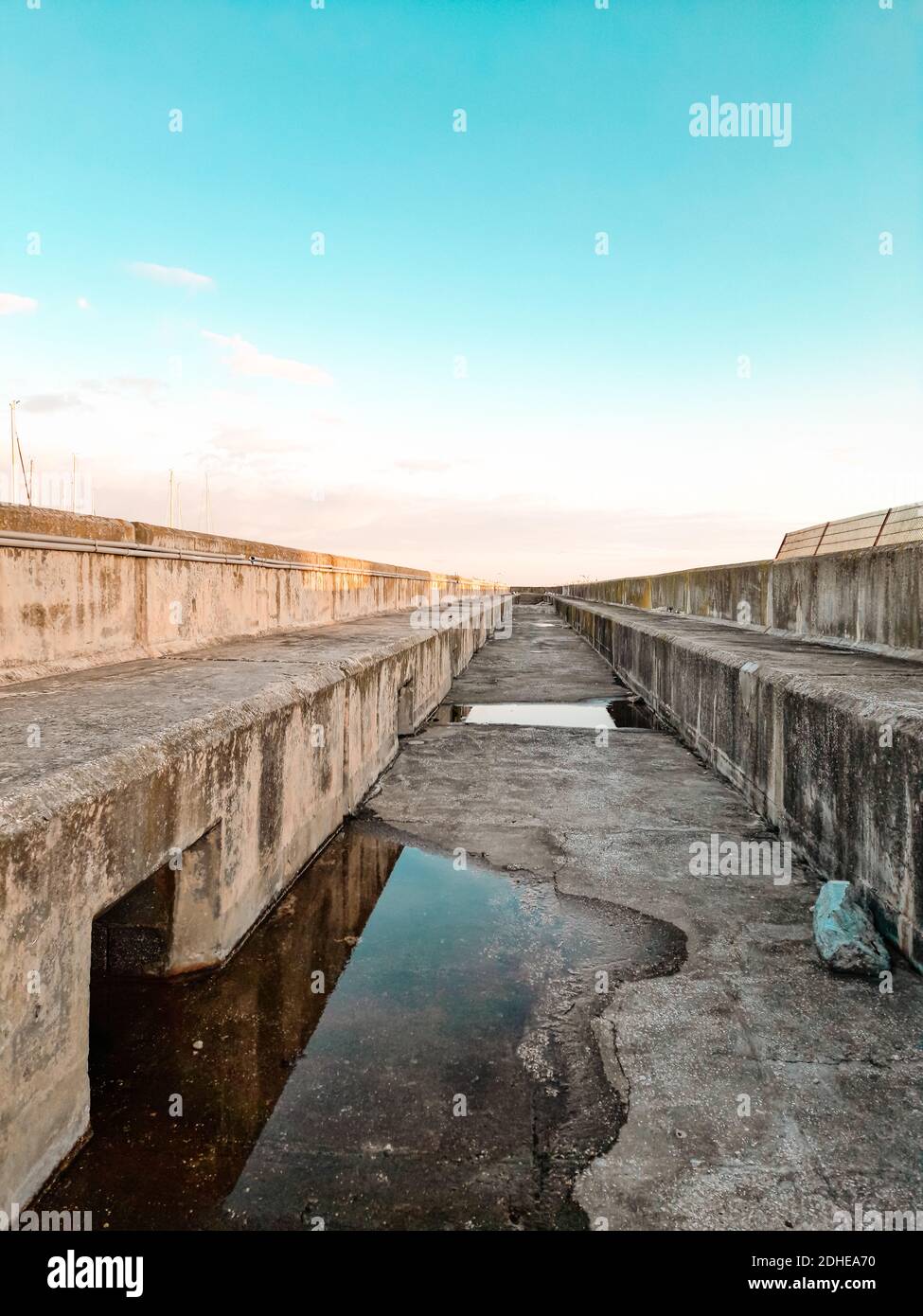 Pier concrete structure at the sunset Stock Photo - Alamy