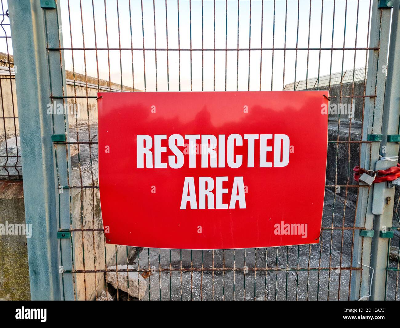 Restricted area sign in a metal fence. Keep out. Warning Stock Photo ...
