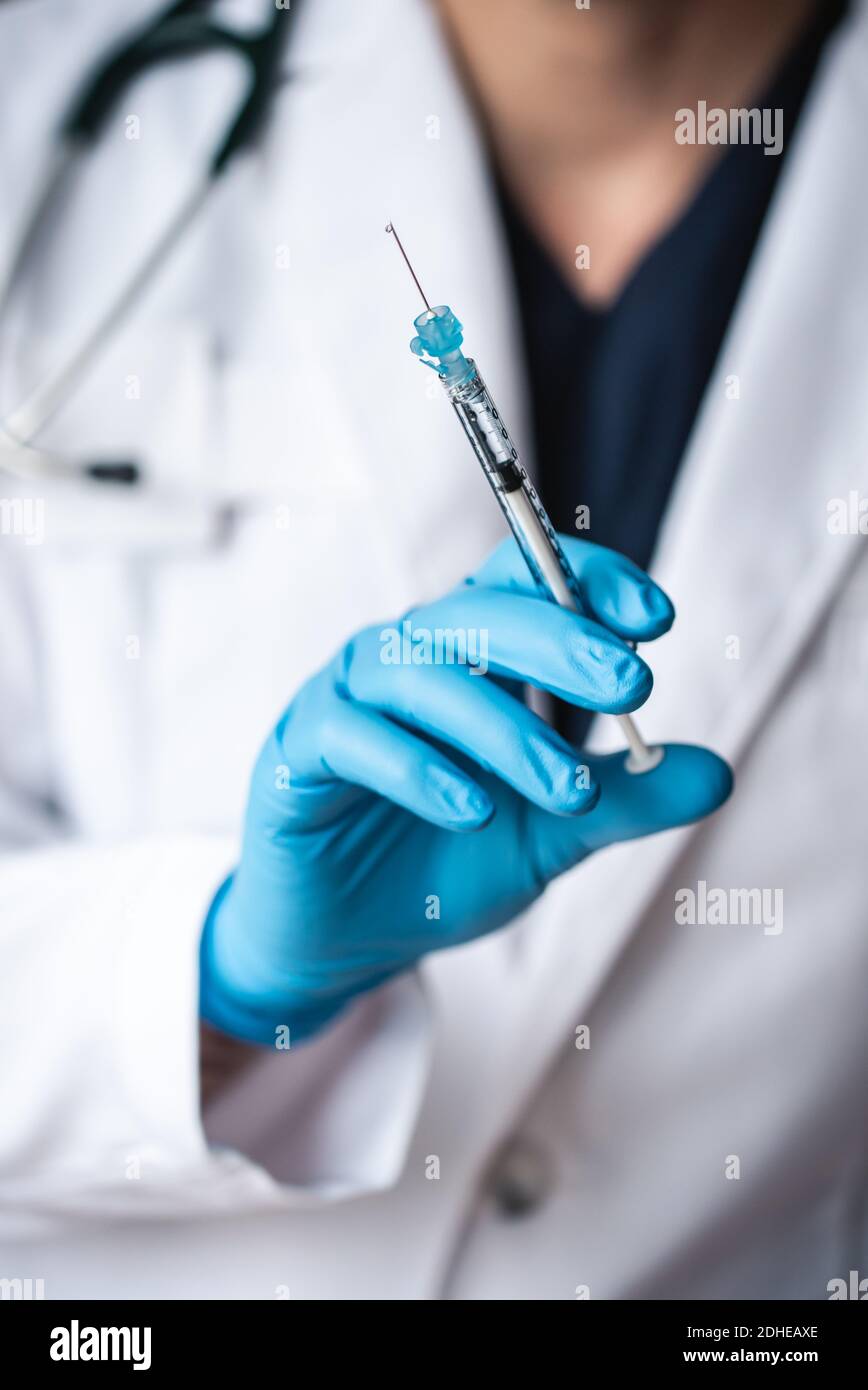 Close up of doctor holding needle with vaccine ready to inject Stock ...