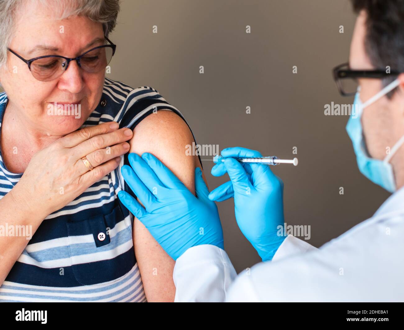 Woman getting vaccine shot by doctor hi-res stock photography and ...